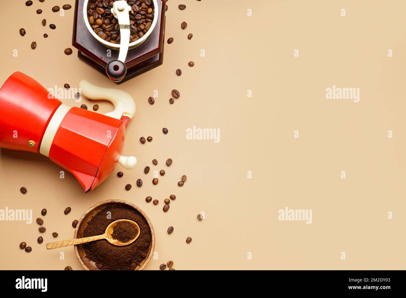 Geyser coffee maker, grinder, bowl of powder and beans on beige ...