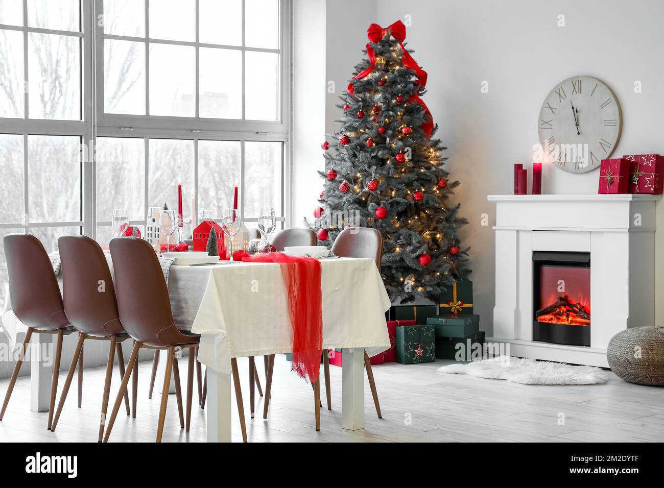 Christmas table setting with candle holders and fir trees in dining ...
