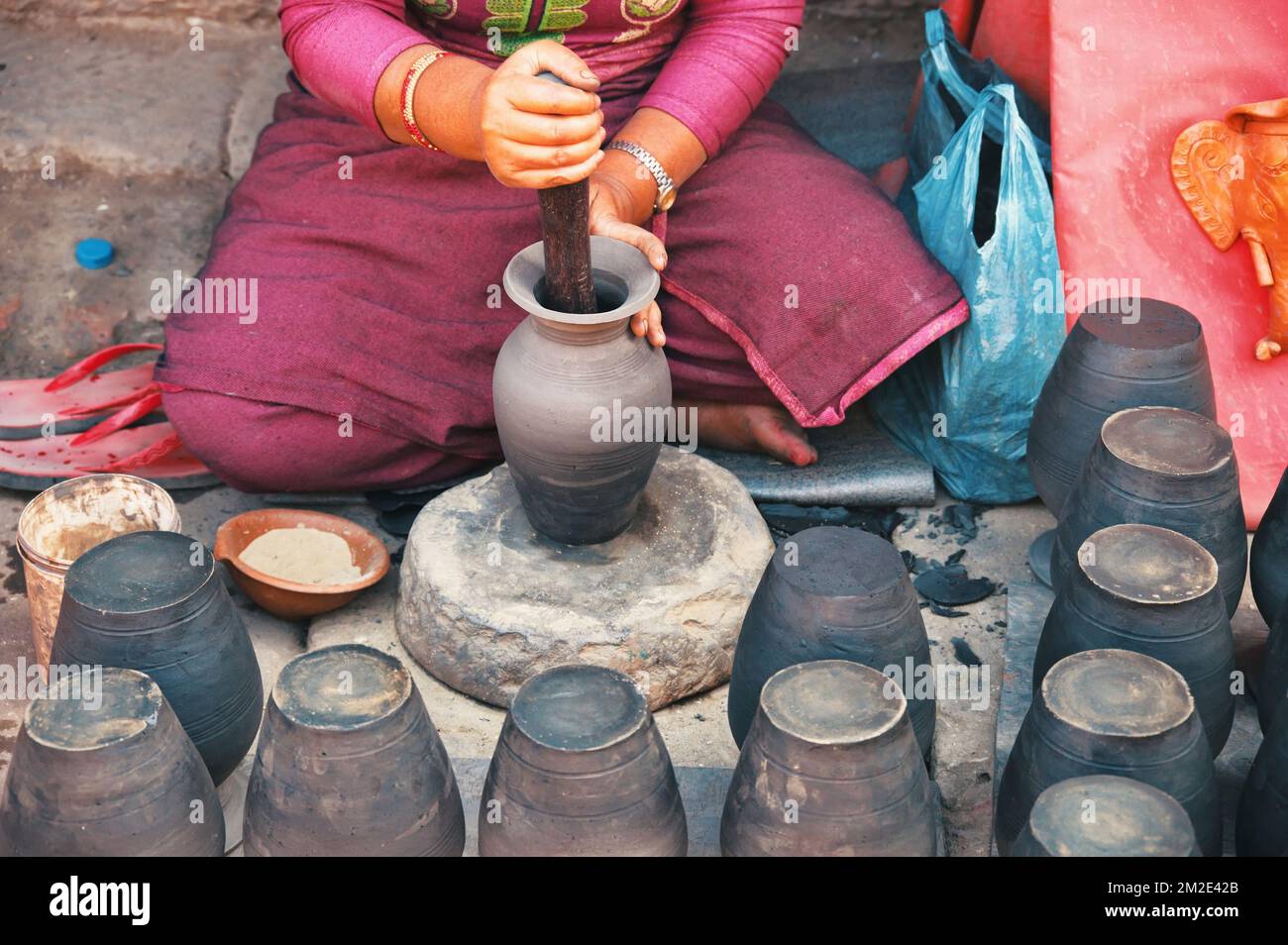 Midsection of professional potter making bowl in pottery workshop ...