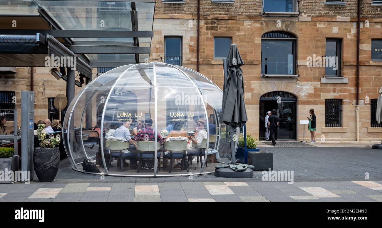 Outdoor transparent domed dining area with diners in historic Rocks ...
