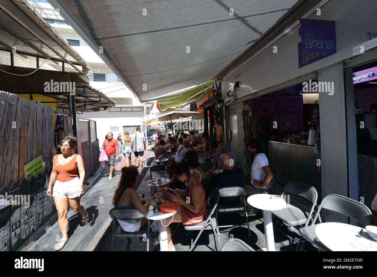 Vibrant bars in the narrow street of the Carmel market in Tel-Aviv ...