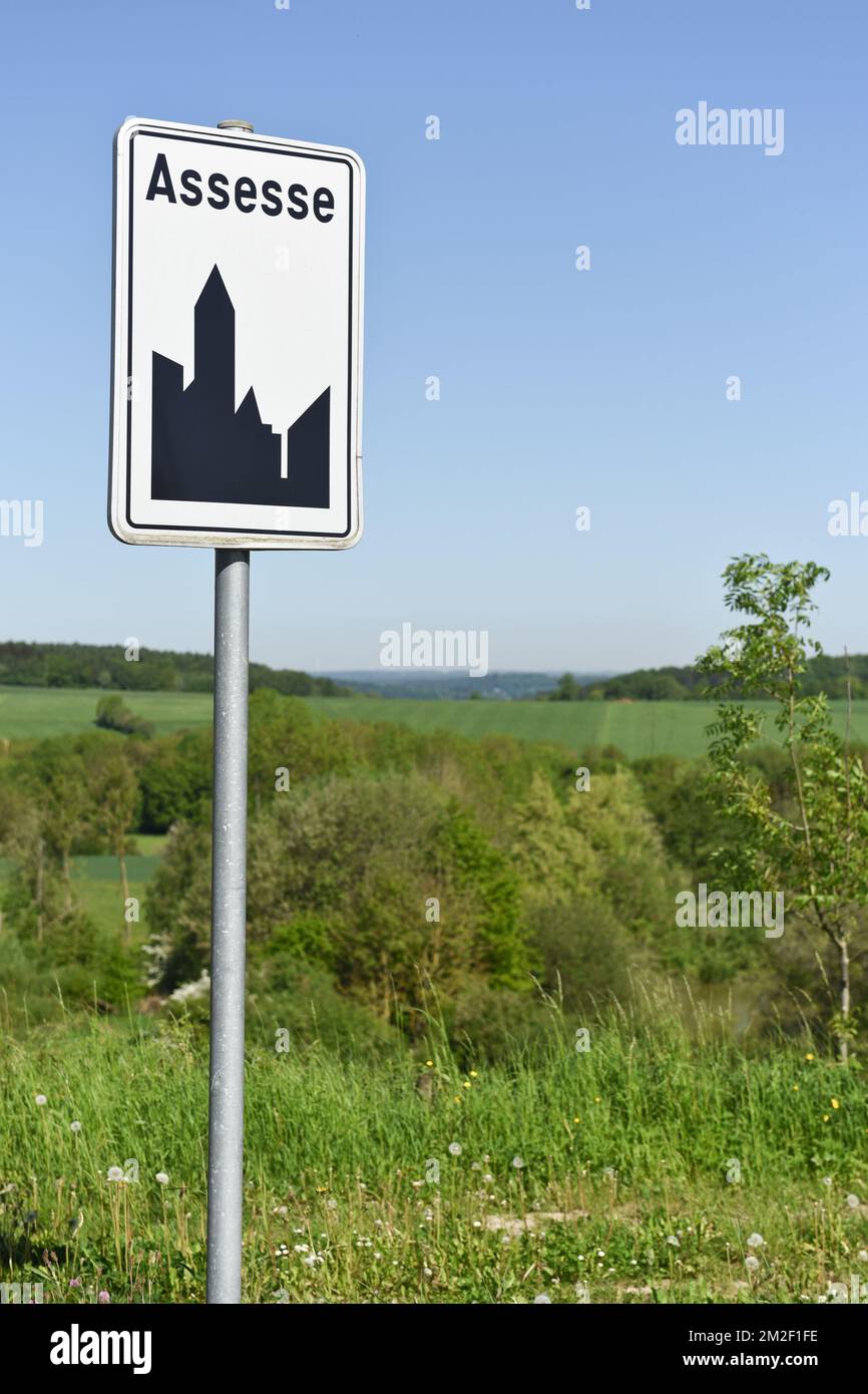 Illustration shows the name of the Assesse municipality on a road sign ...