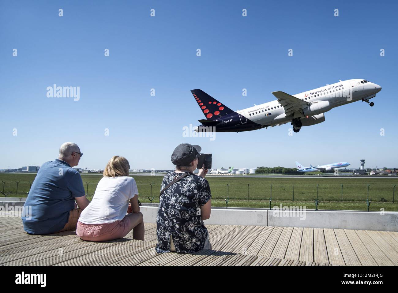 Plane spotters on aircraft spotting platform watching airplane from ...