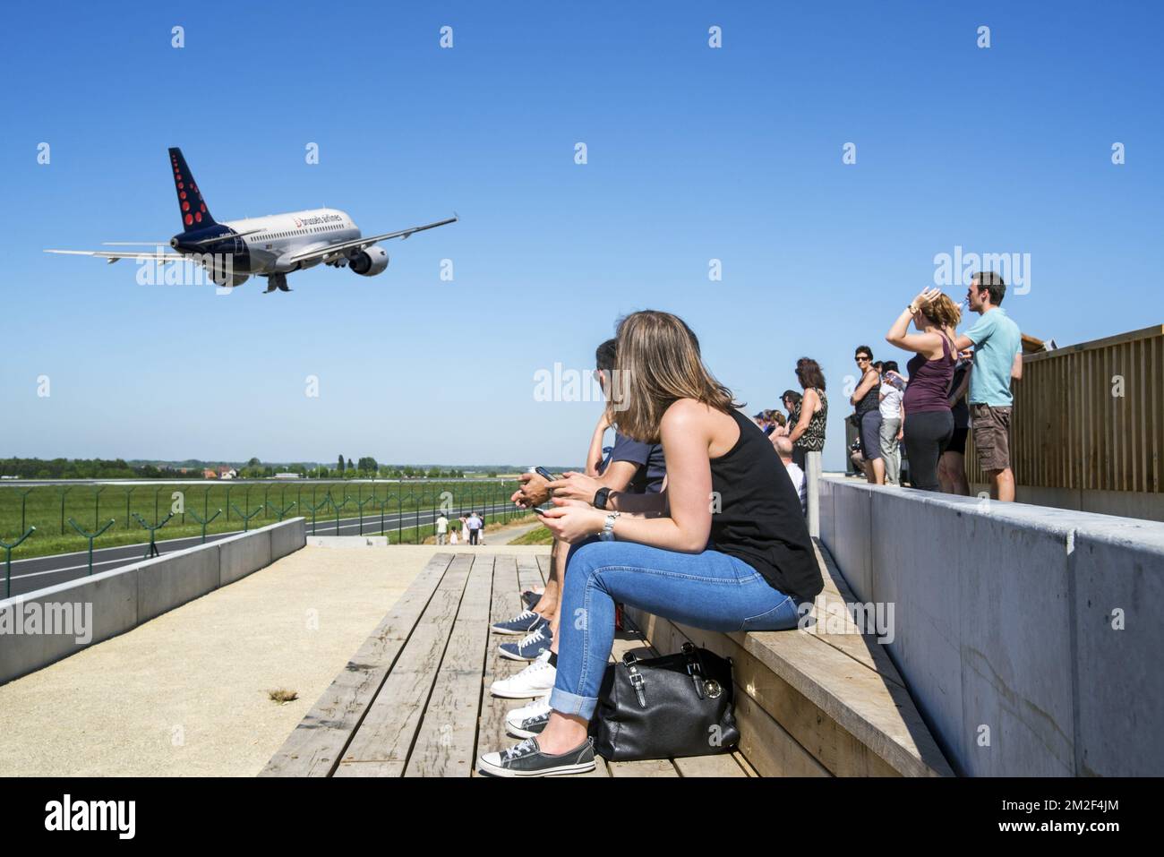 Plane spotters on aircraft spotting platform watching airplane from ...