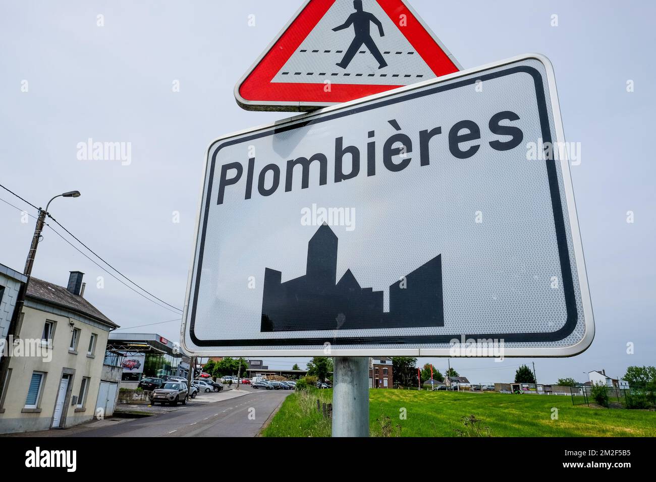 Illustration shows the name of the Plombieres municipality on a road ...