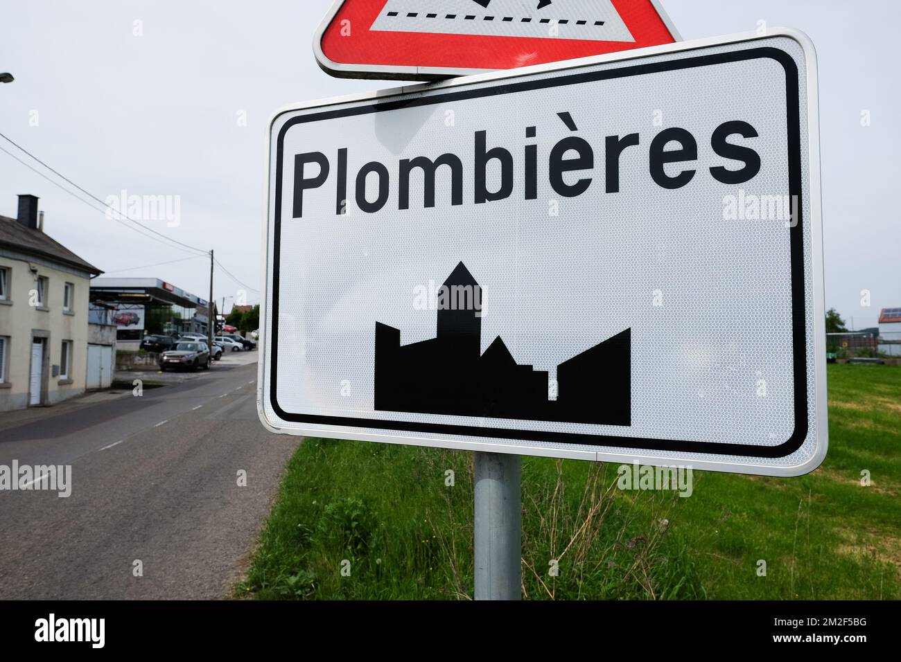 Illustration shows the name of the Plombieres municipality on a road ...