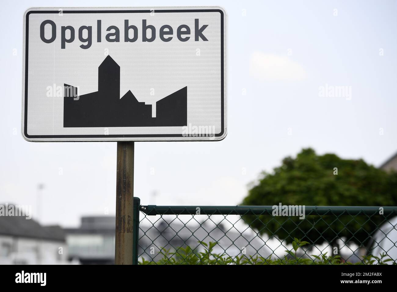 Illustration shows the name of the Opglabbeek municipality on a road ...