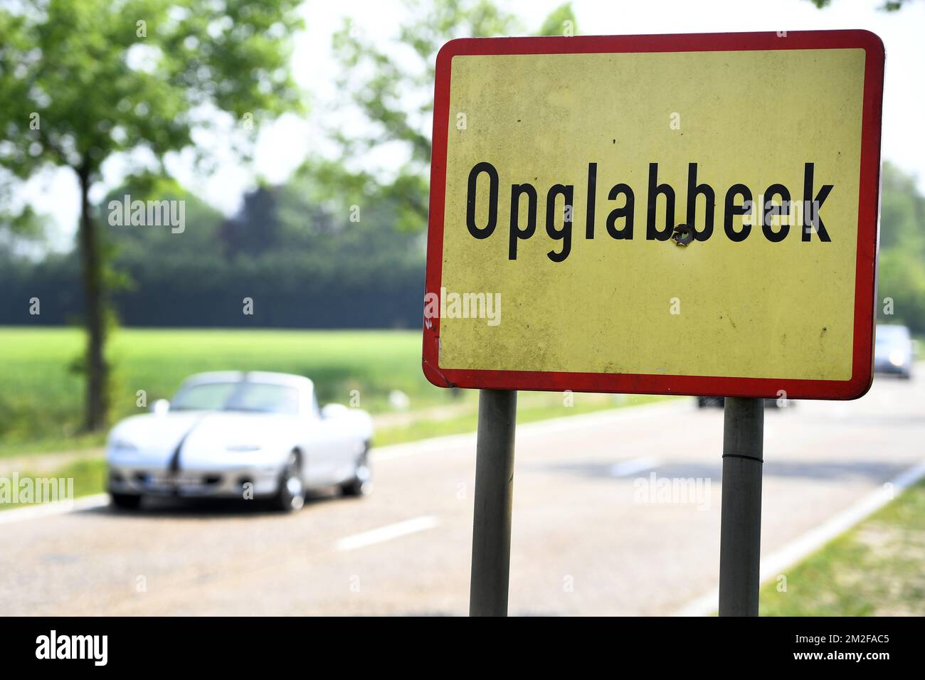 Illustration shows the name of the Opglabbeek municipality on a road ...