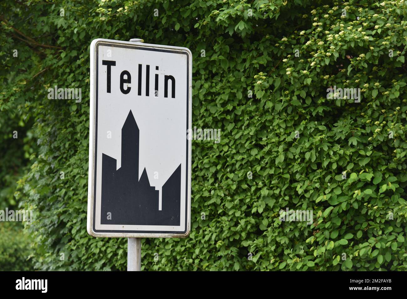 Illustration shows the name of the Tellin municipality on a road sign ...