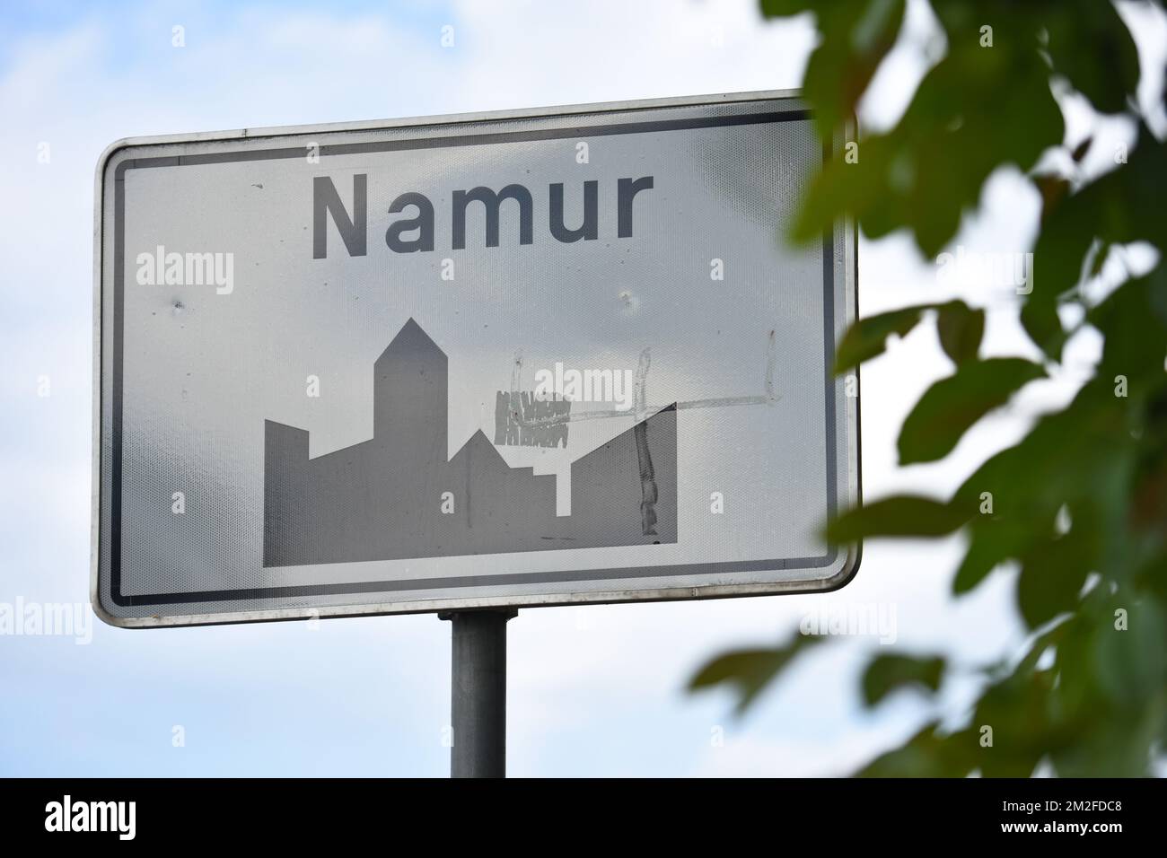 Illustration shows the name of the Namur municipality on a road sign ...