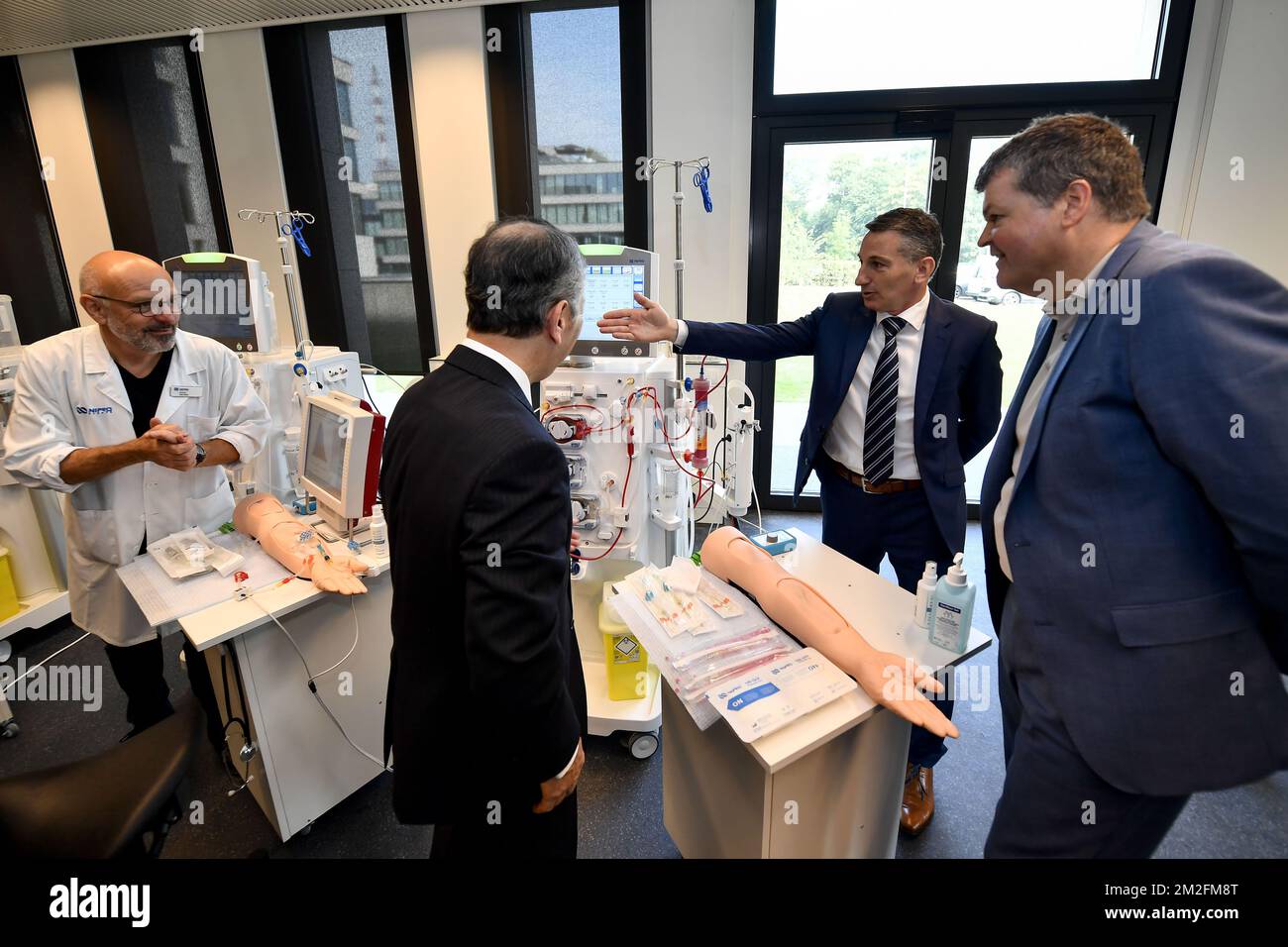 CEO Nipro Medical Europe Serge Kemps (C) and Mechelen mayor Bart Somers ...