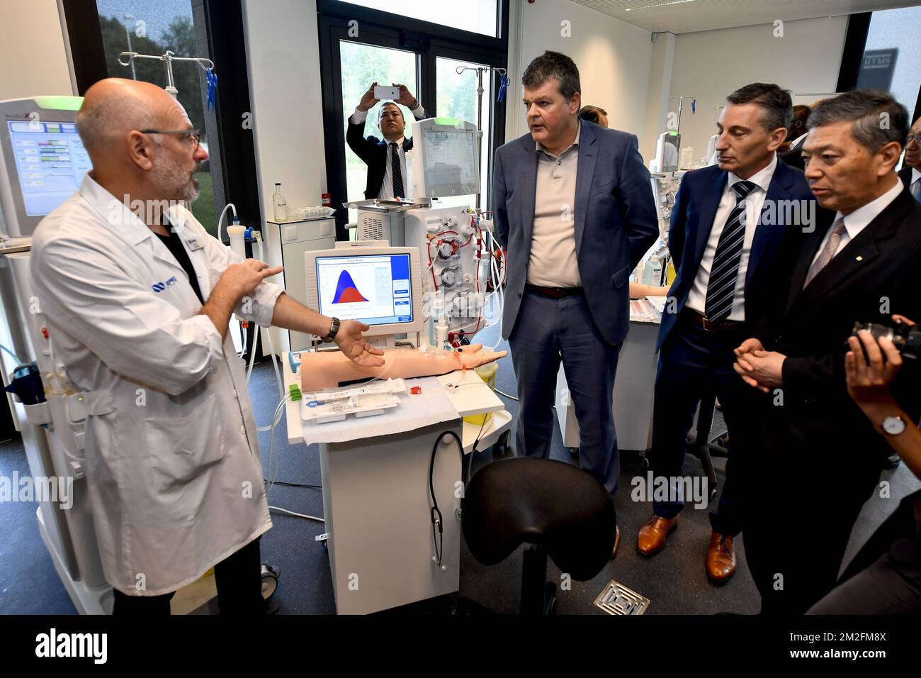 Mechelen mayor Bart Somers (C) and CEO Nipro Medical Europe Serge Kemps ...
