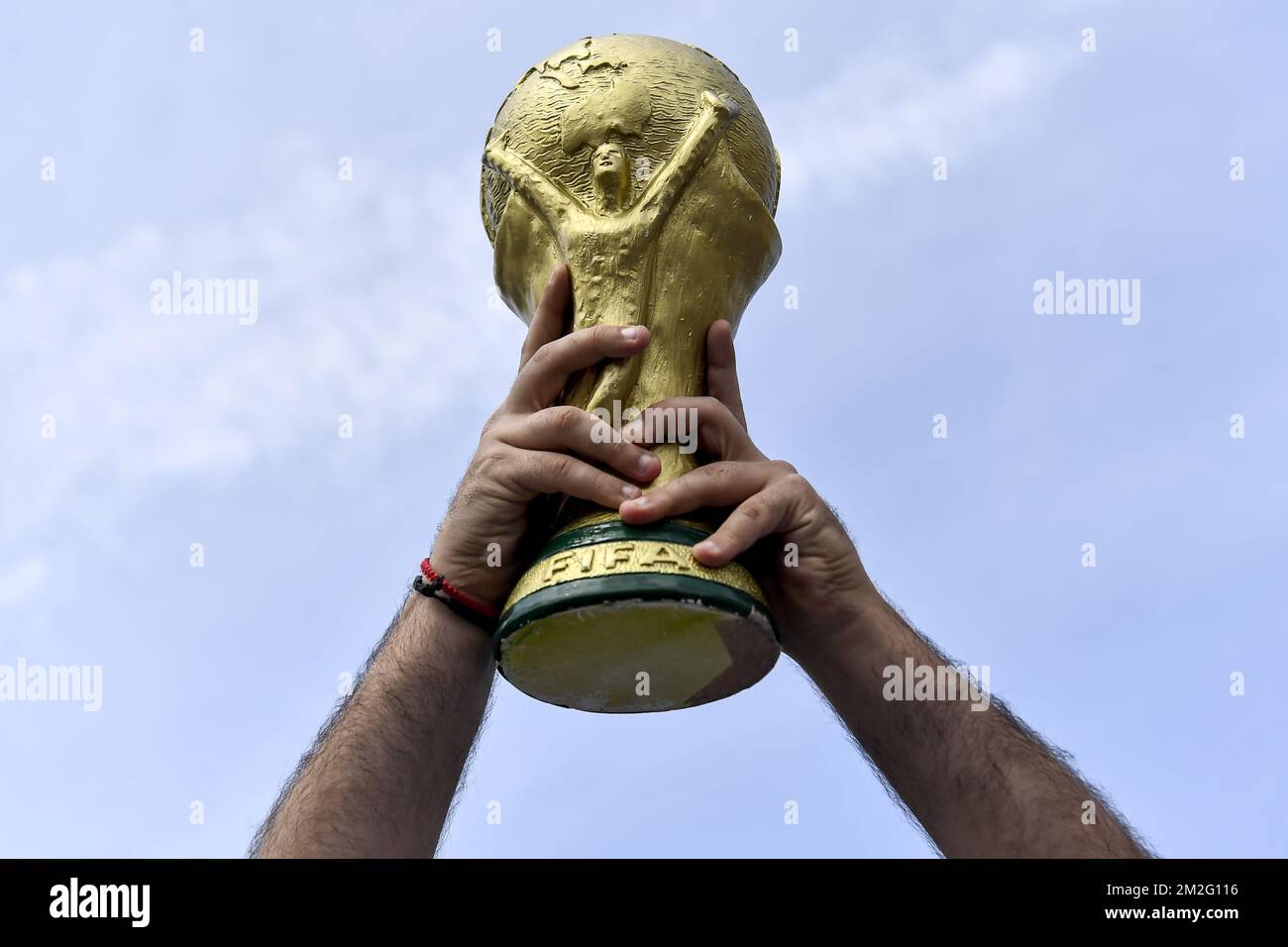 Illustration shows someone holding a fake FIF world cup pictured in the ...