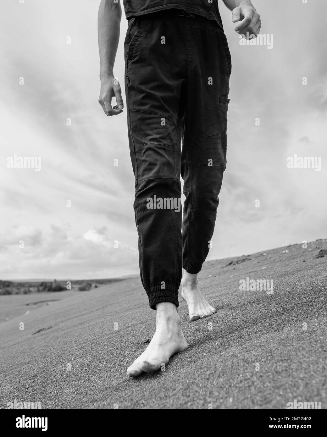Male feet walking on sand hi-res stock photography and images - Alamy