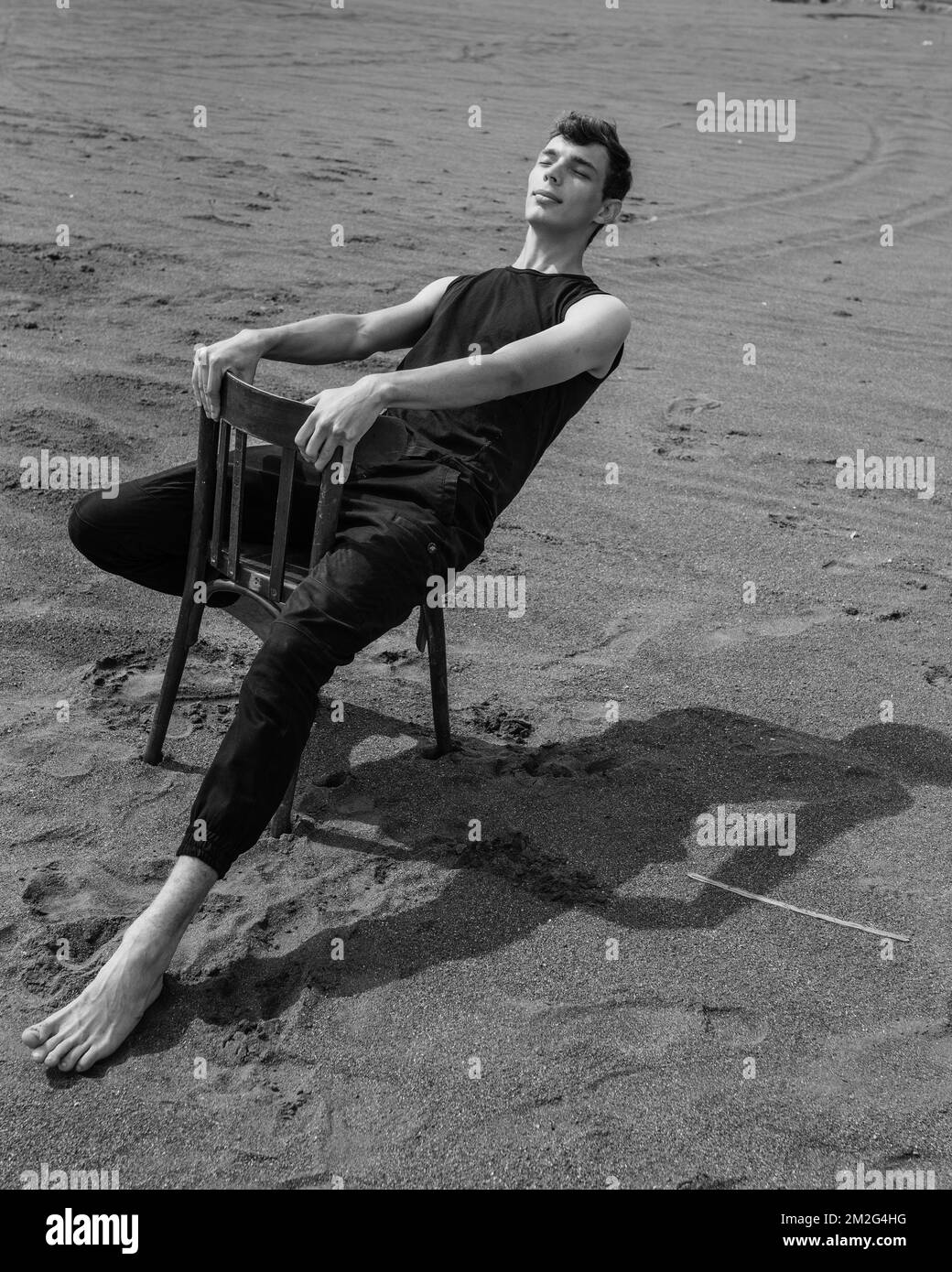 Lone Man sitting on chair in desert Stock Photo - Alamy