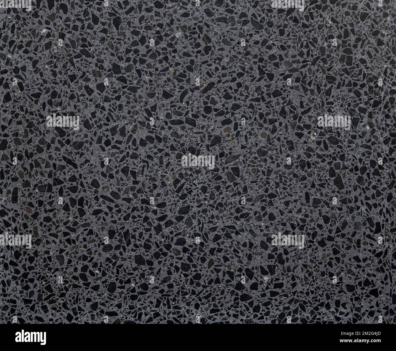 Gray terrazzo stone flooring with dark grey flecks, viewed from above ...