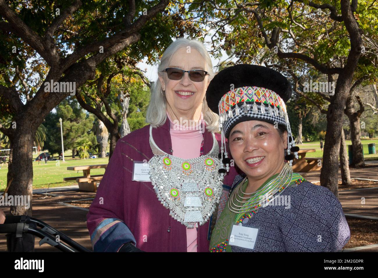 White female historian receives a silver necklace from Hmong female ...