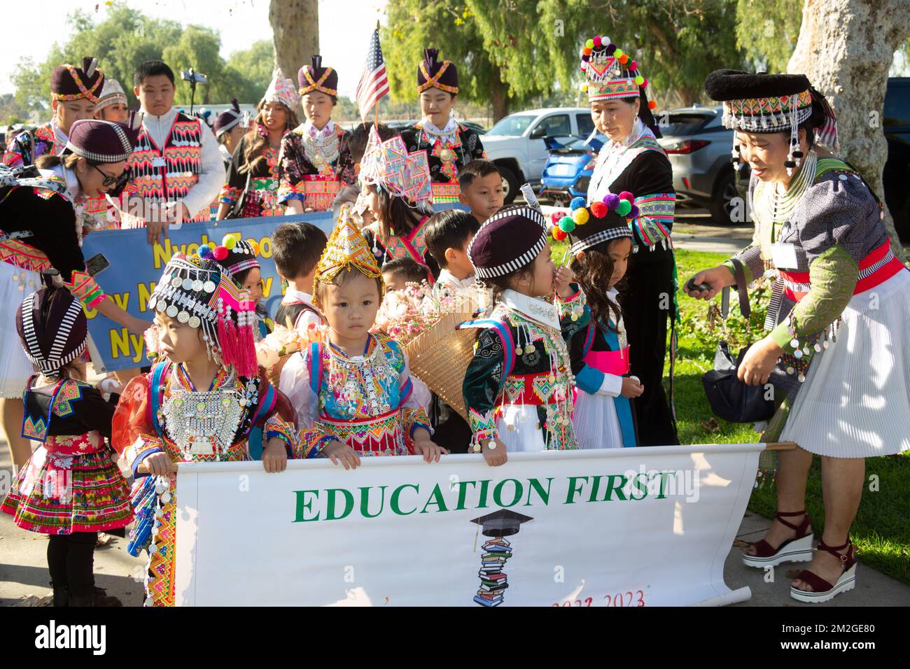 Children in traditional attire carry an Education First banner in the ...