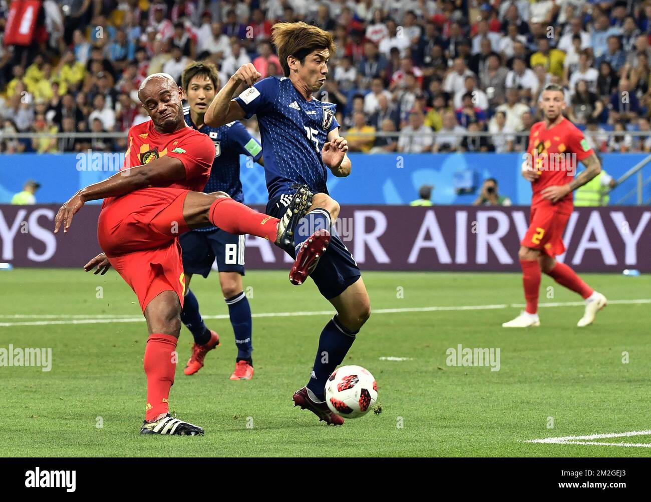 Belgium's Vincent Kompany and Japan's Yuya Osako fight for the ball ...