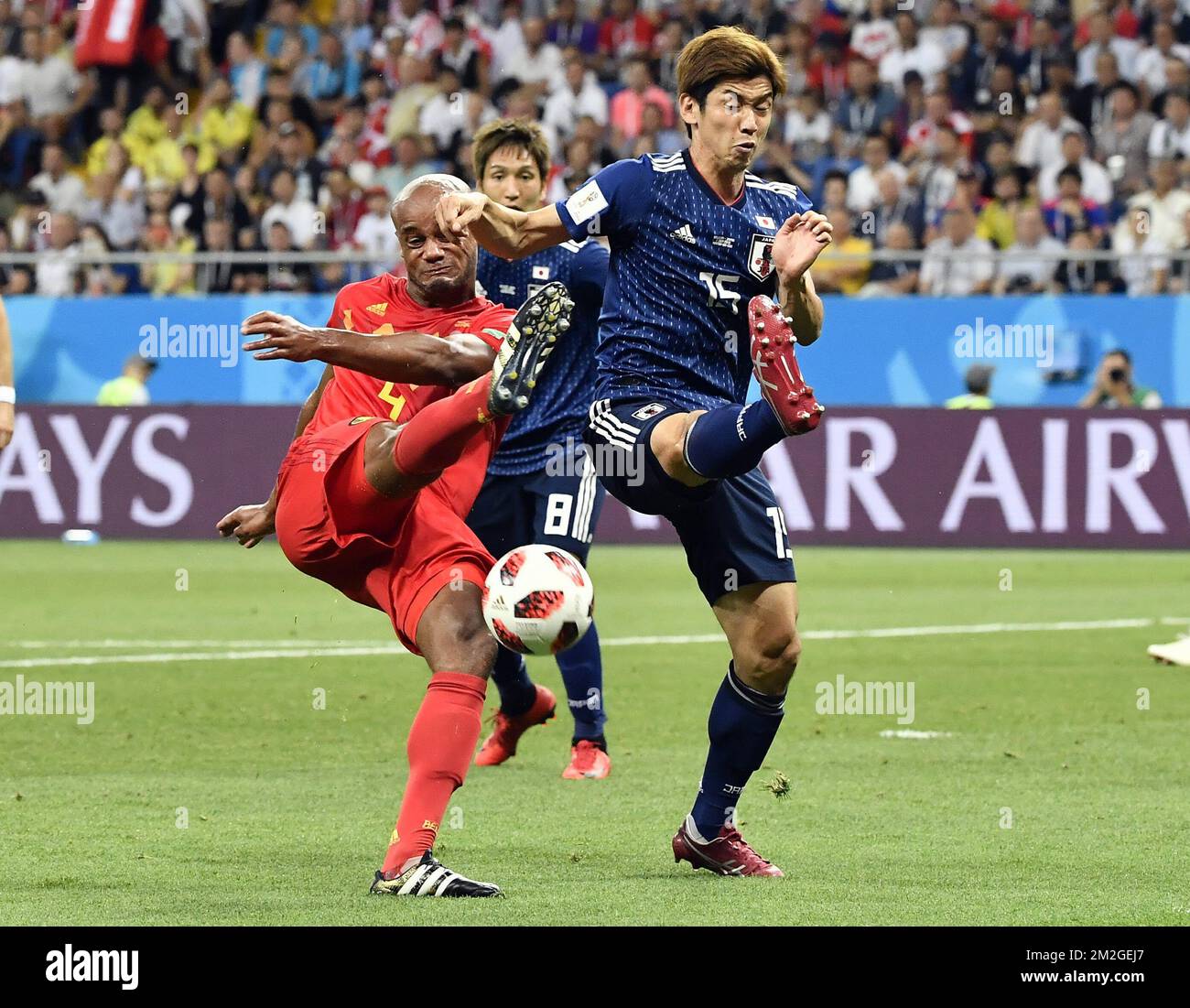 Belgium's Vincent Kompany and Japan's Yuya Osako fight for the ball ...