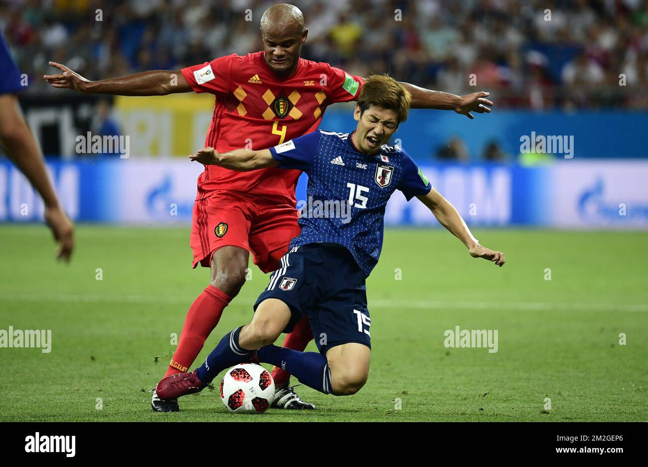 Belgium's Vincent Kompany and Japan's Yuya Osako fight for the ball ...