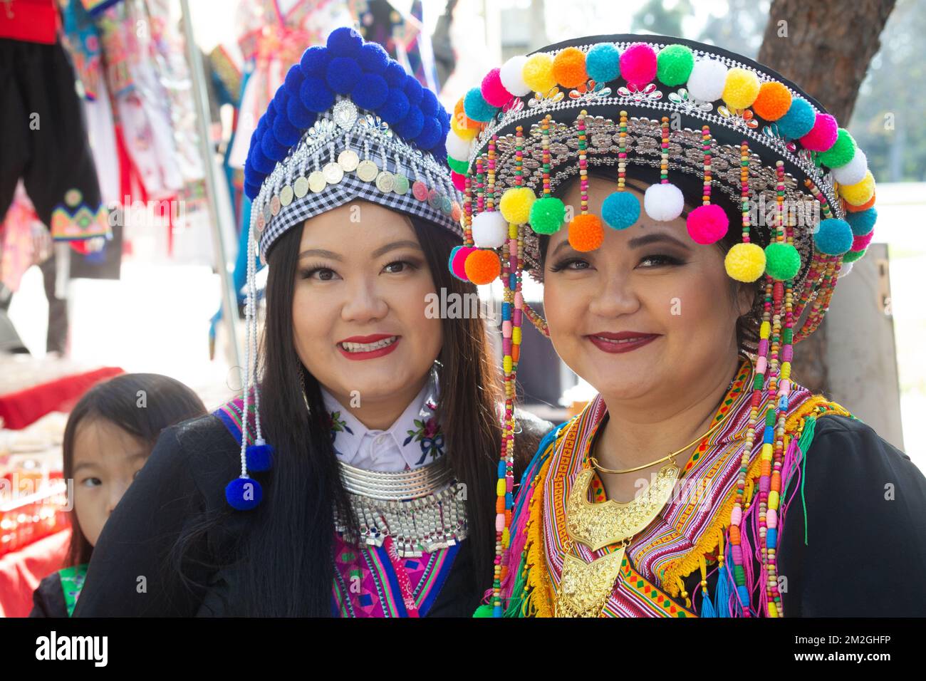 Portrait of two Hmong women in traditional attire at the Hmong New Year ...