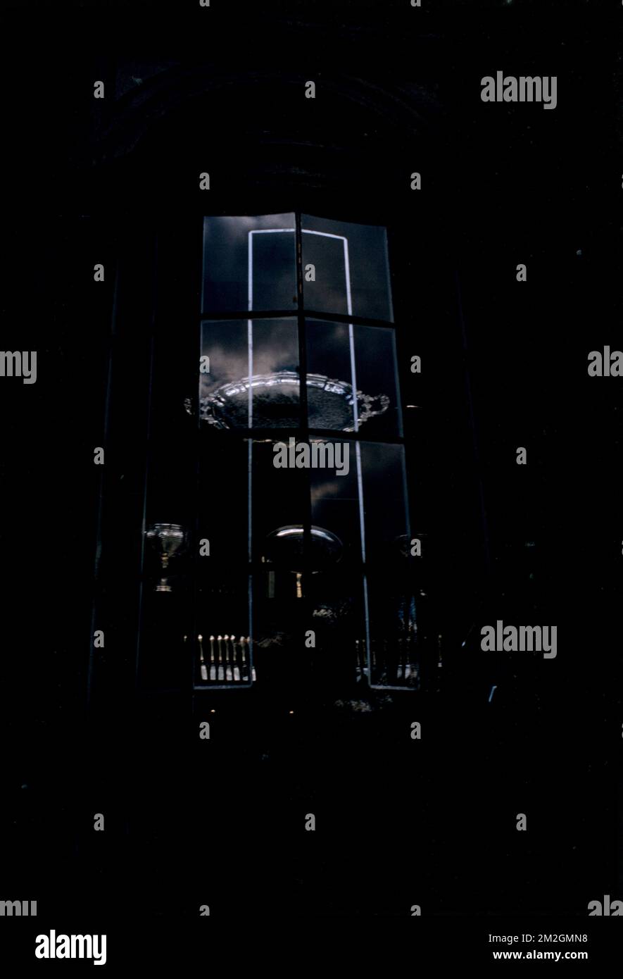 Dim view of silver objects through shop window , Window displays ...