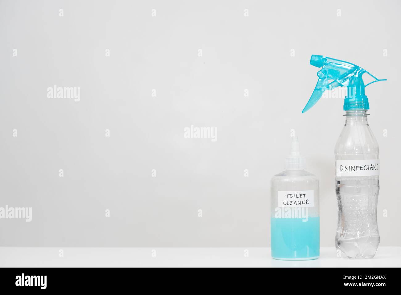 Home cleaning products with labels in reused plastic bottles. Recycled ...