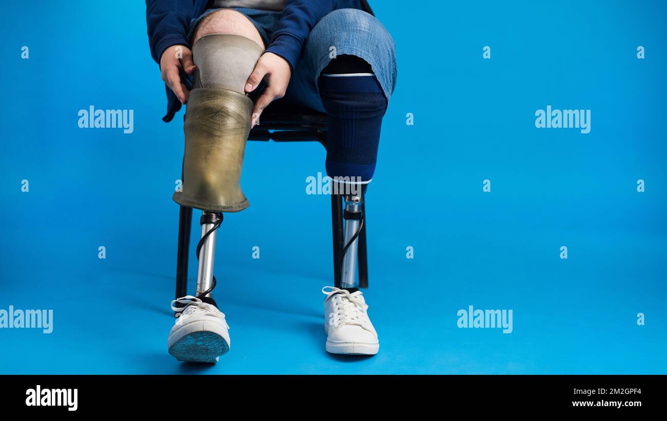 View of a man with prosthetic legs and white sneakers. Removing the ...