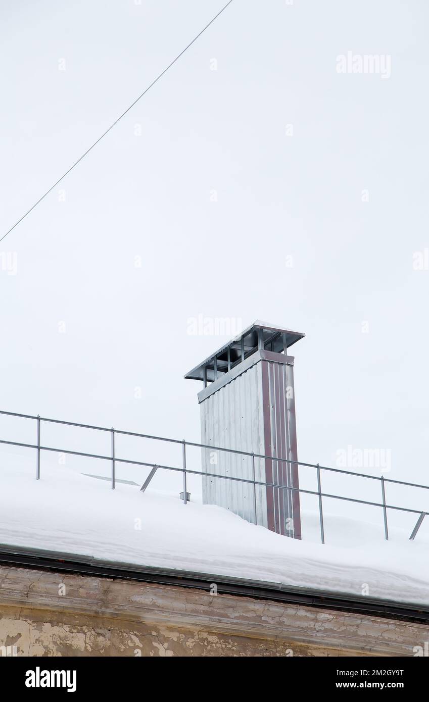 Smoke, rectangular, metal exhaust pipe on the roof of a modern house ...