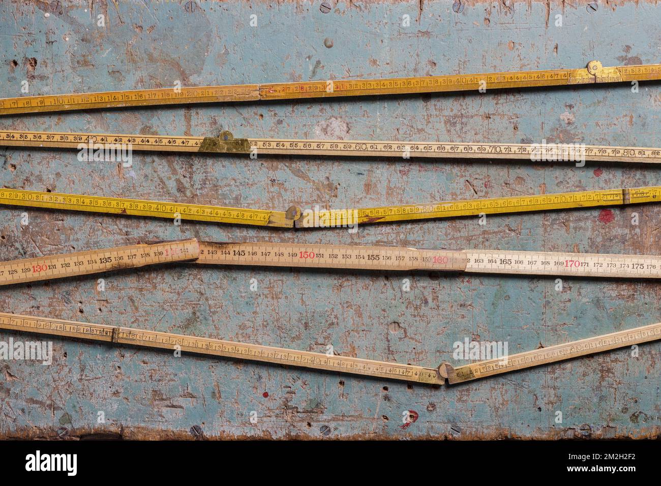 Vintage folding rulers on a worn wooden background flat lay Stock Photo ...