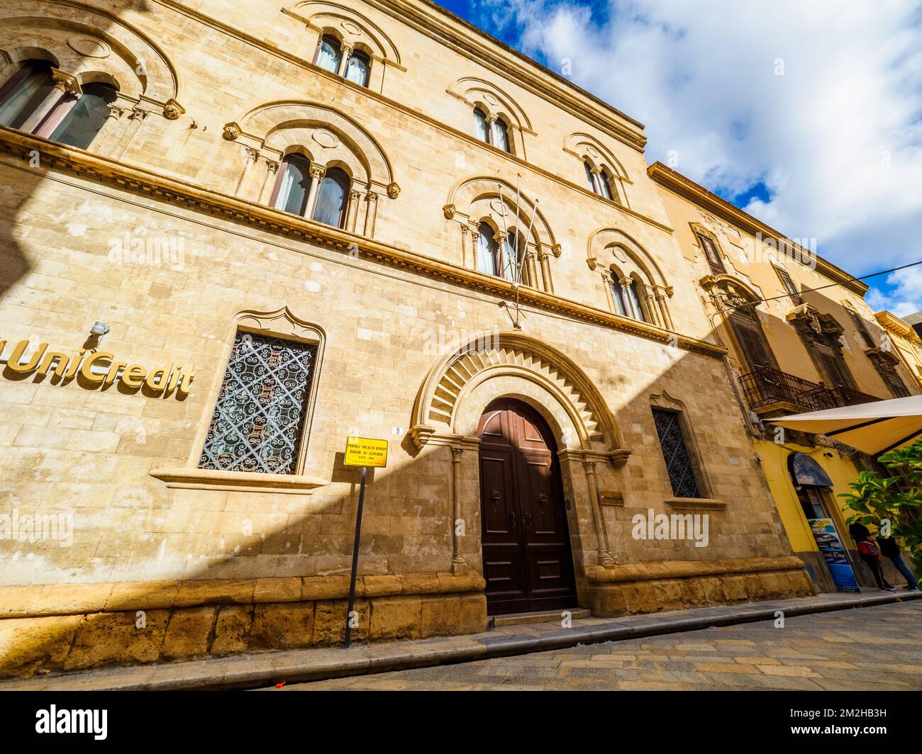 Facade with a beautiful portal with a large ogival arch and saw tooth ...