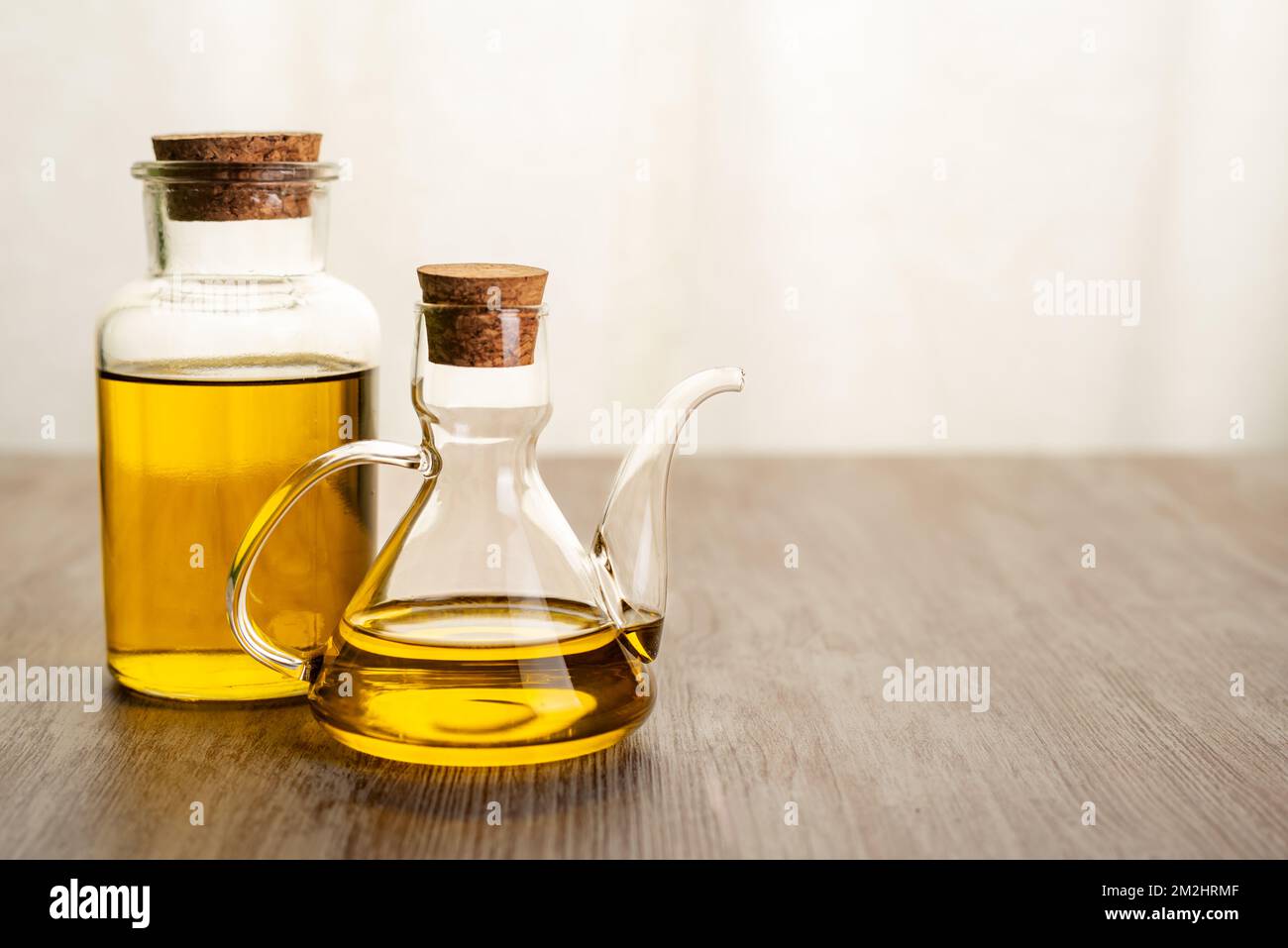 Oil cans with extra virgin olive oil on a counter with a background of ...