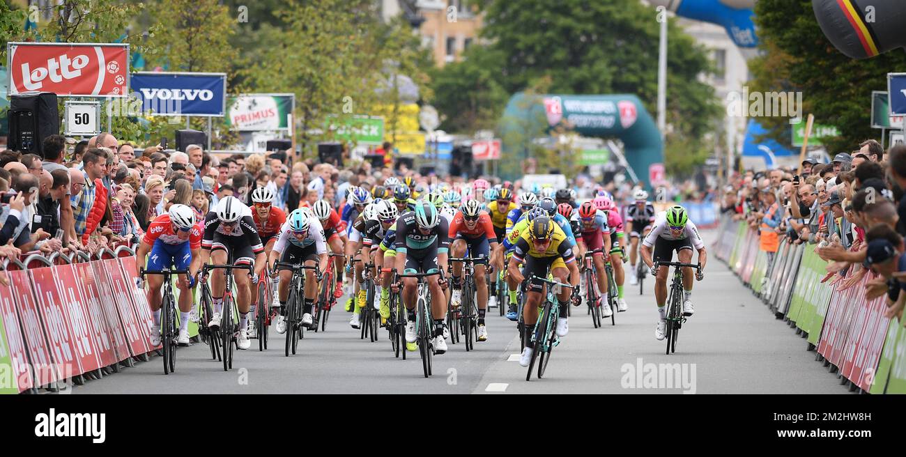 Illustration picture shows pack of riders crosses the finish line of ...