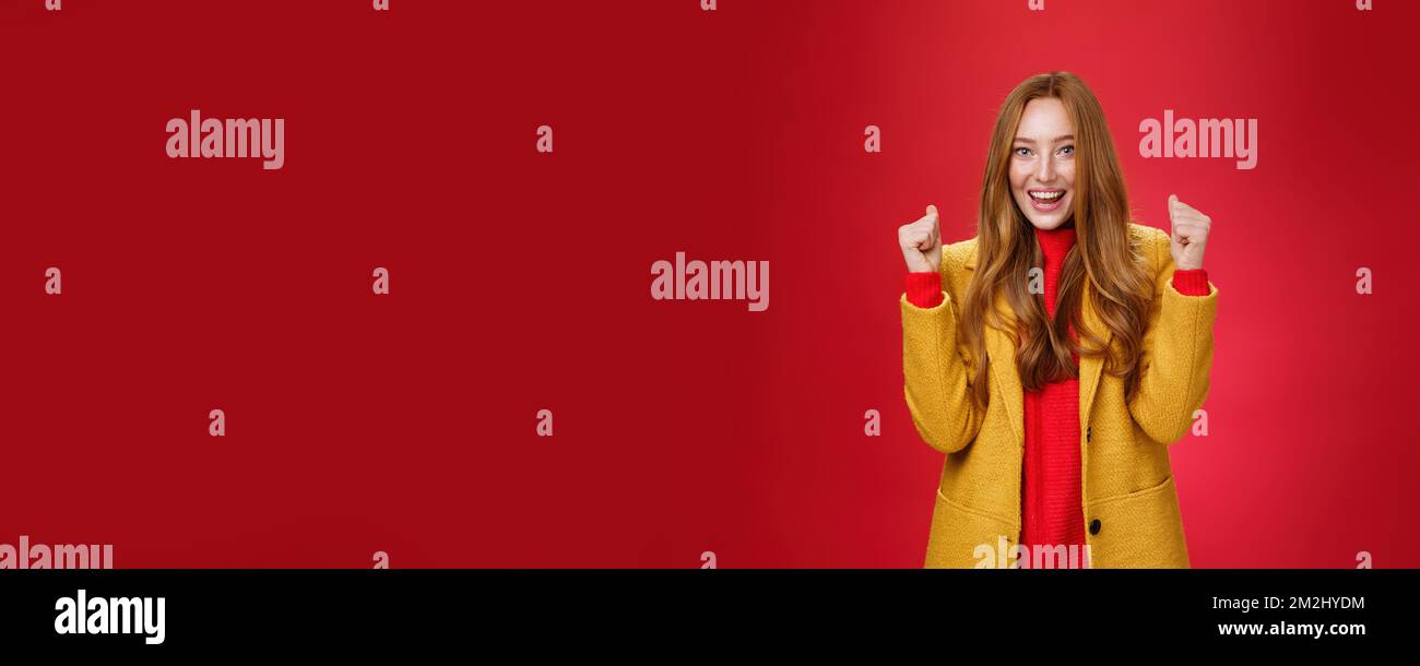 Hooray success. Portrait of happy cheerful and sincere cute ginger ...