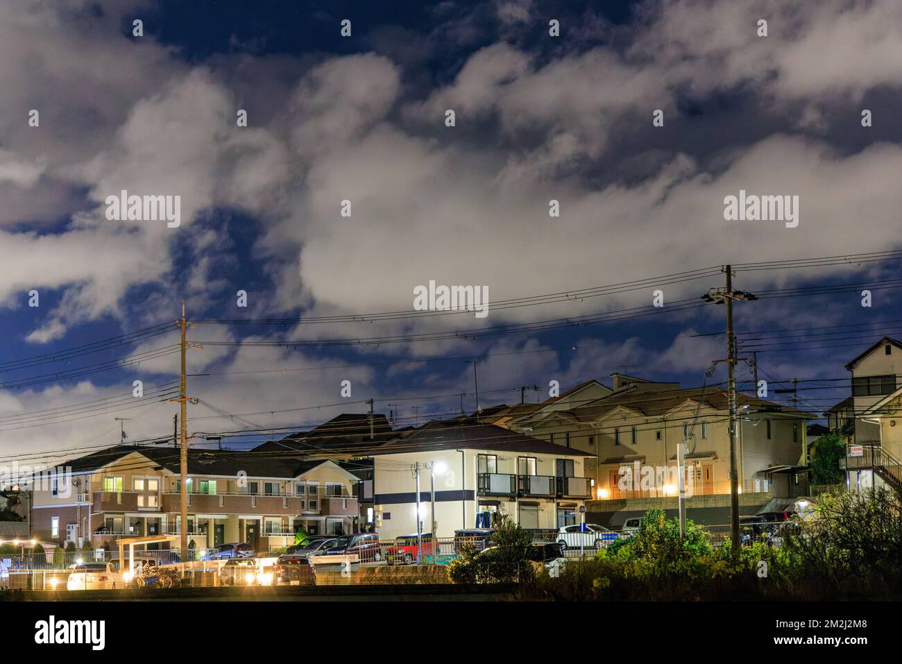 Lights from residential apartment buildings under cloud at night Stock ...