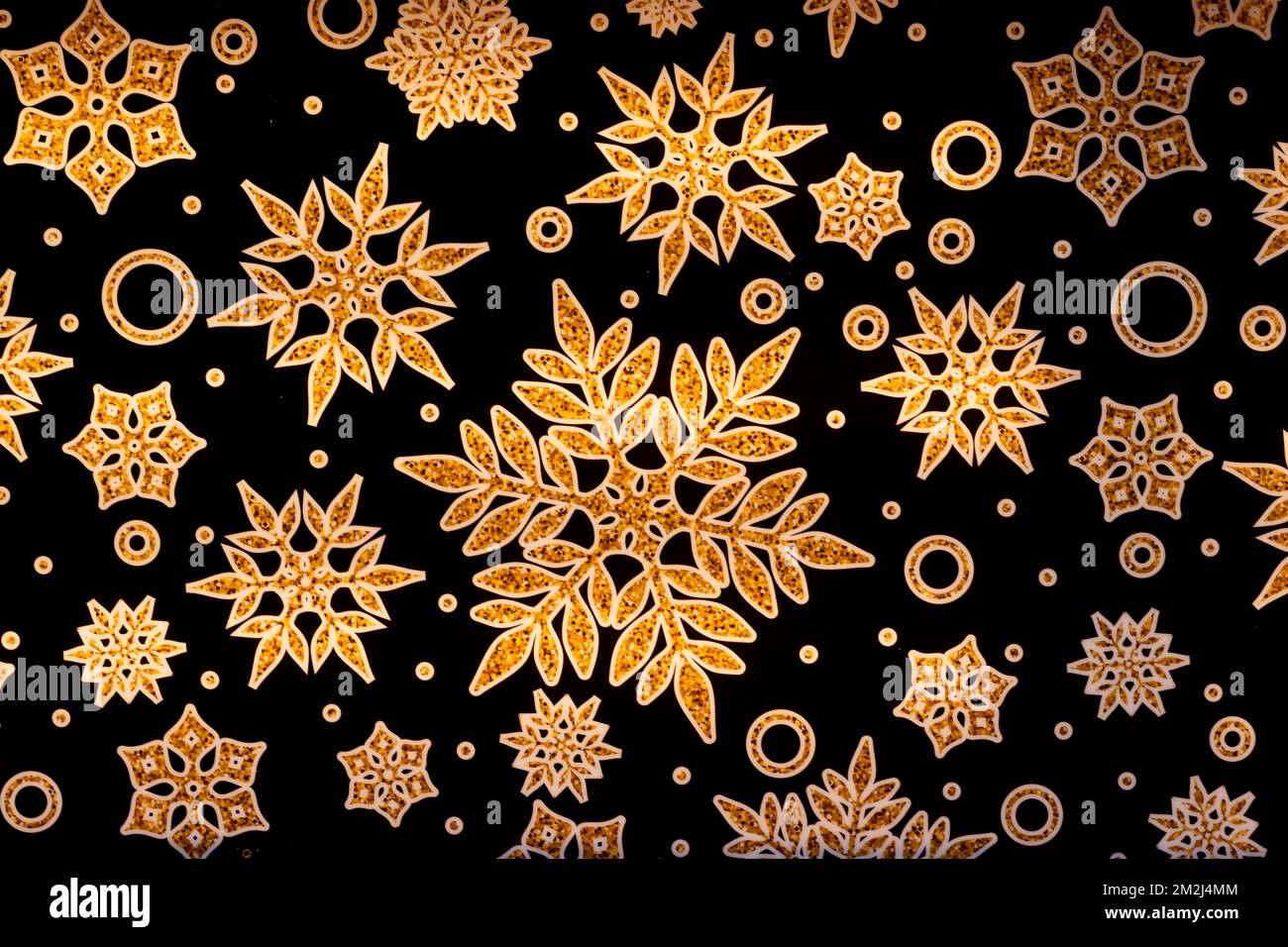 Luminous golden snowflakes against black background decoration at a ...