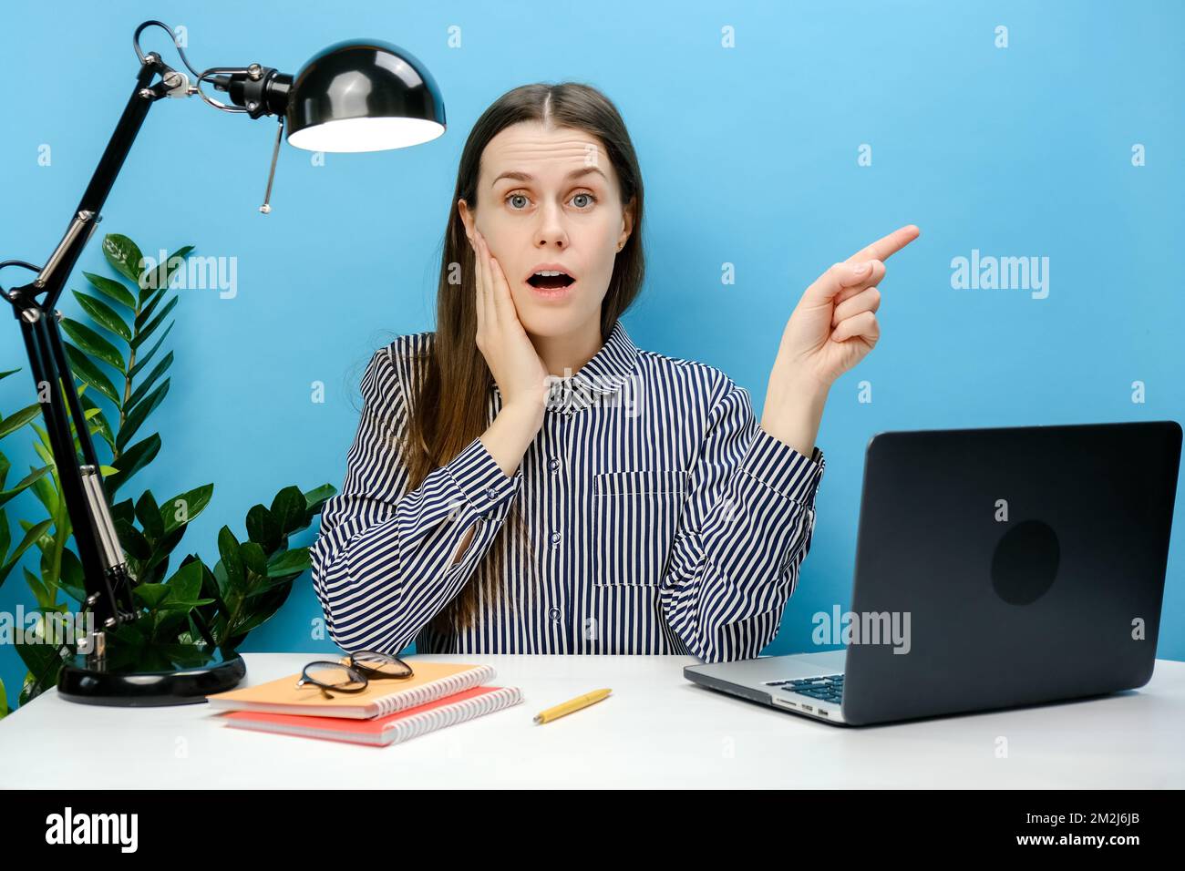 Shocked successful employee young female sit work at office desk with ...