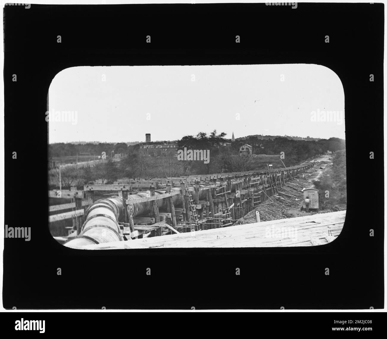 Distribution Department, raising 48-inch pipe on trestle, Beacon Street ...