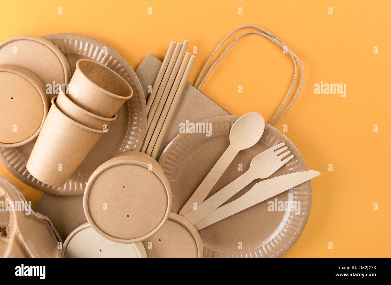 Paper utensils bundle, food packaging articles over orange background ...
