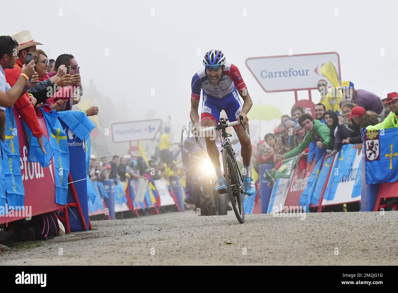 French Thibaut Pinot of FDJ crosses the finish line to win the 15th ...