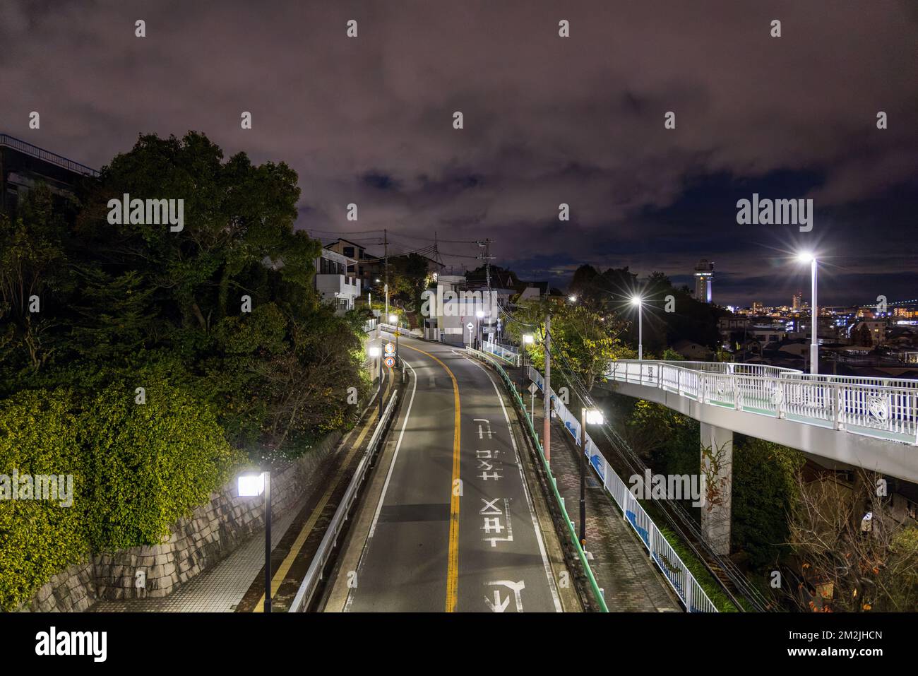 Empty road through quiet hillside neighborhood at night Stock Photo - Alamy
