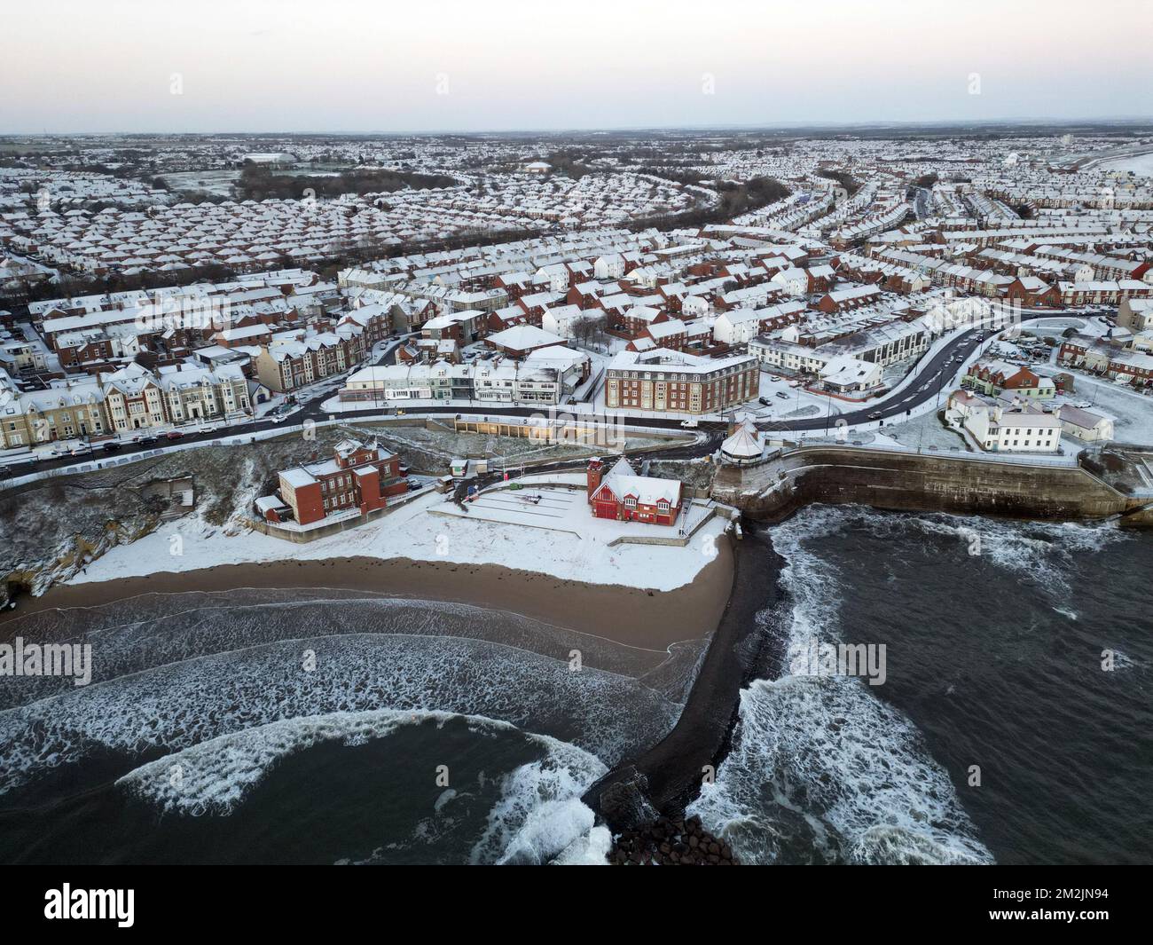 Overnight snow at Cullercoats Bay in North Tyneside. Snow and ice have ...