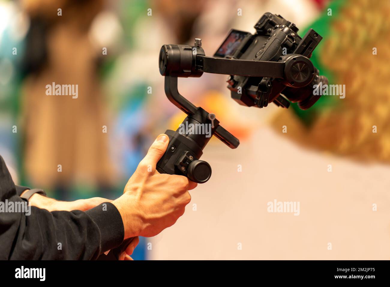 Unrecognizable man carrying stabilizer with modern camera while ...