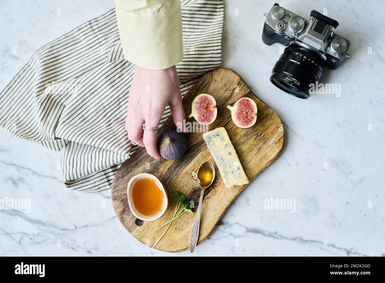 High angle view of photographer making still life with exotic fruits ...