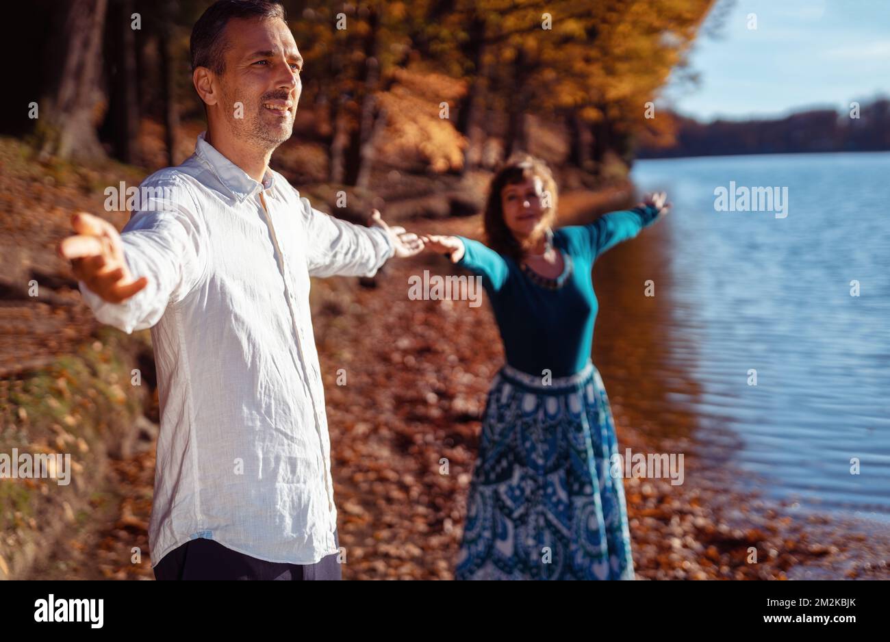 romantic couple in love by the lake in autumn Stock Photo - Alamy