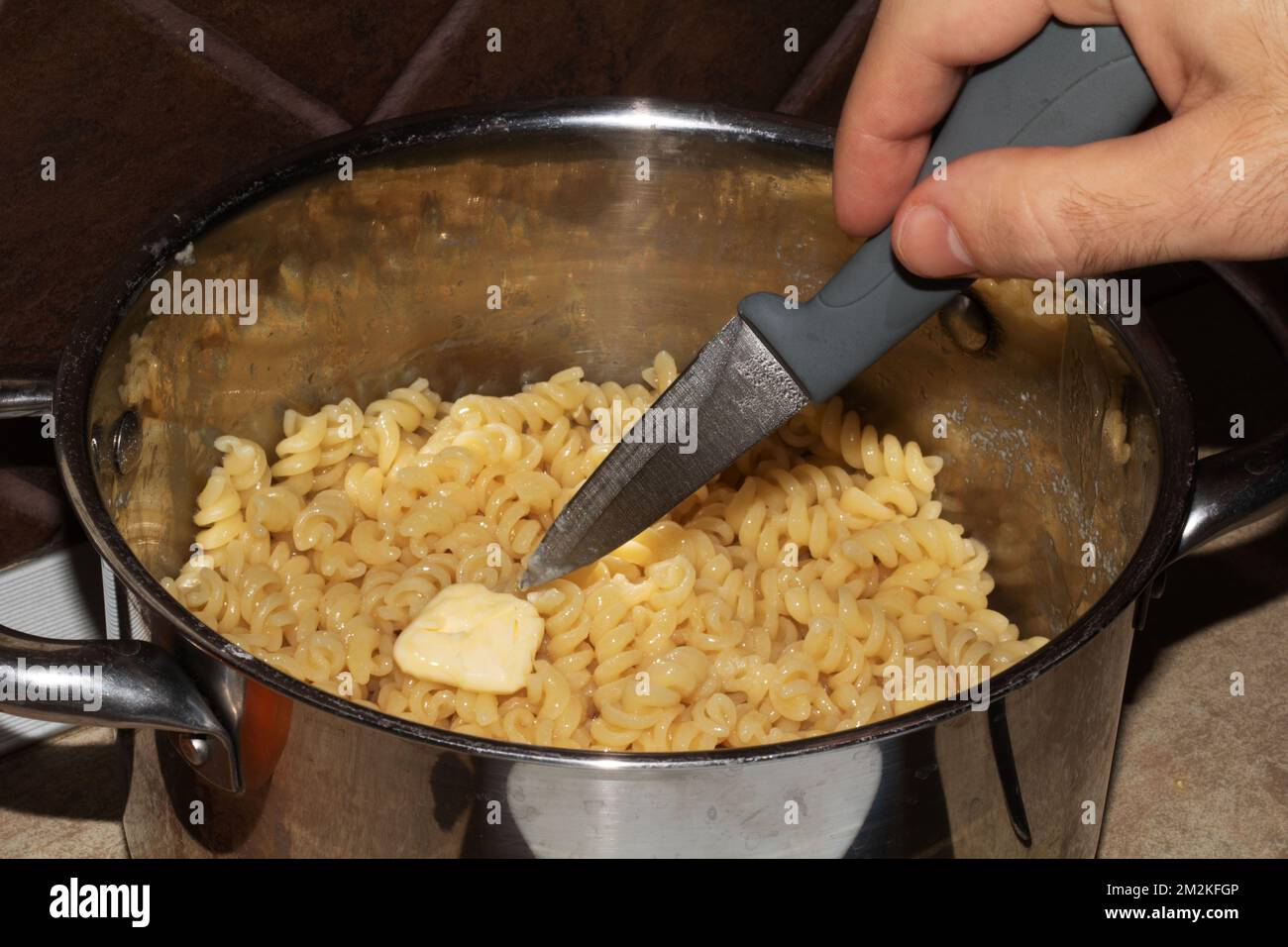 photo pasta with a dollop of butter in a saucepan Stock Photo - Alamy