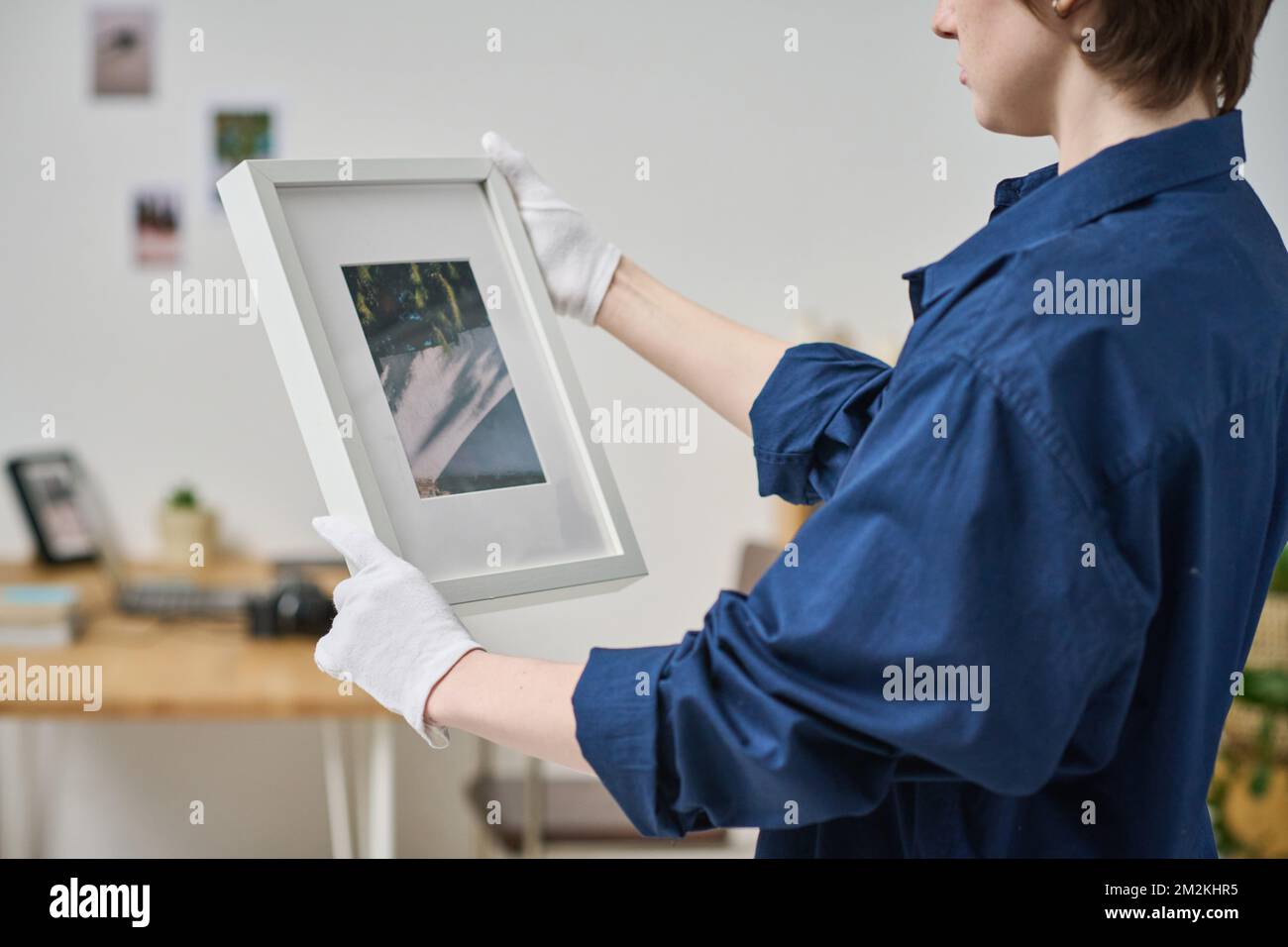 Young photographer holding frame with her professional photo in the ...