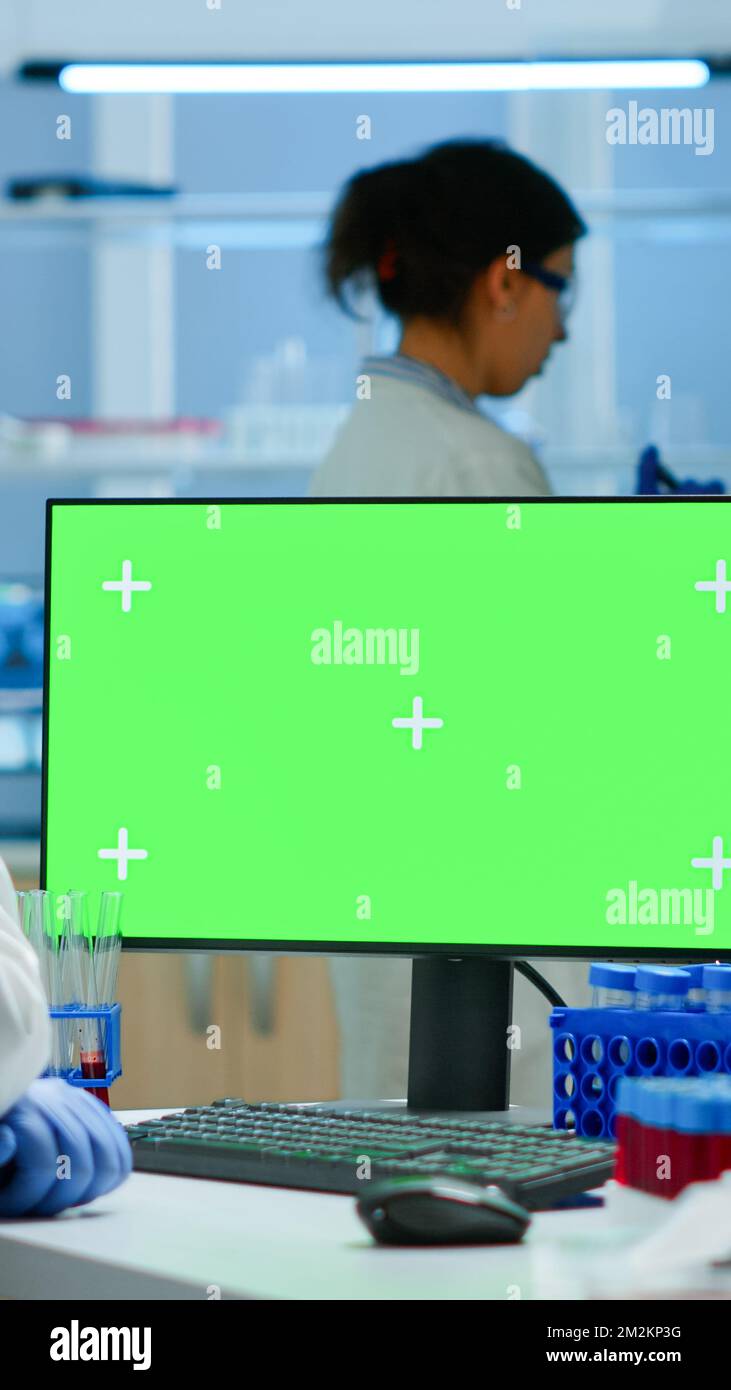 Researcher looking at chroma key display in modern equipped lab ...