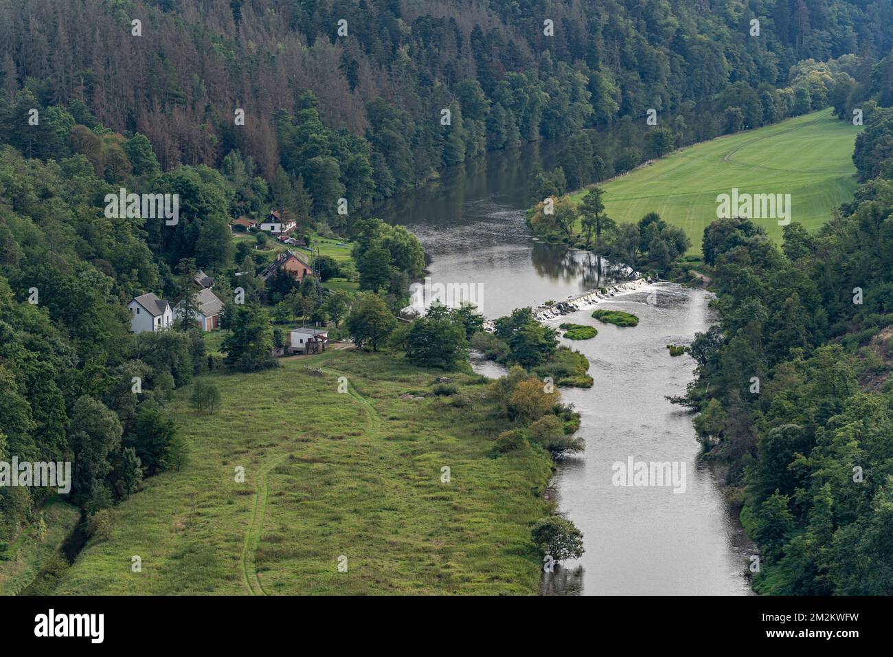 The Berounka river between mountains covered in forests in the Czech ...